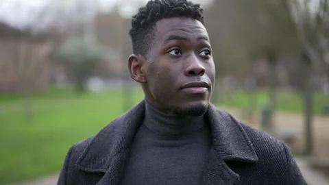 Young black man walking outside at park ... | Stock Video | Pond5
