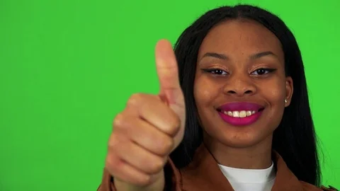 A young black woman shows a thumb up to ... | Stock Video | Pond5