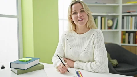 Young blonde woman student sitting on ta... | Stock Video | Pond5