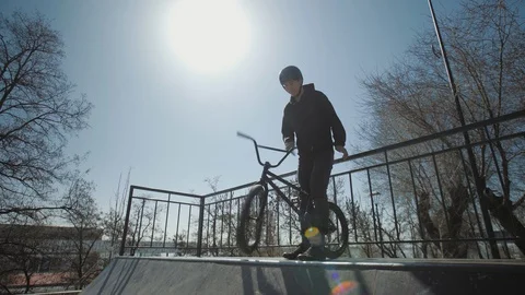 A young bmx rider standing on the top of... | Stock Video | Pond5