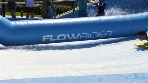 Young boy boarding on a wave machine/flo... | Stock Video | Pond5