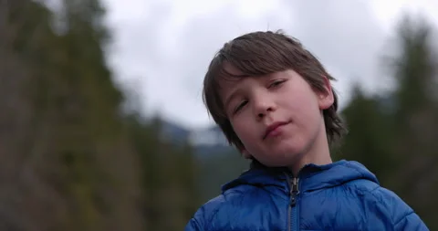 Young boy with deep thinking expression ... | Stock Video | Pond5