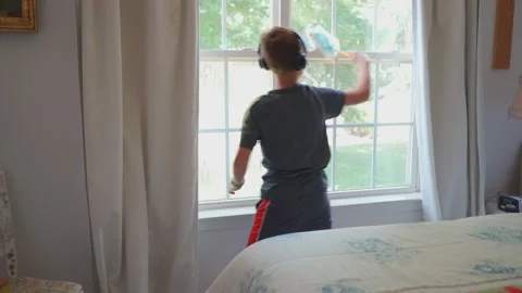 Young boy dusting furniture in house cho... | Stock Video | Pond5