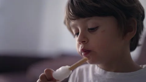 Young boy eating popsicle ice cream. Kid... | Stock Video | Pond5