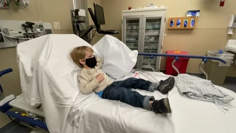 Young Boy in Emergency Room Hospital Bed... | Stock Video | Pond5