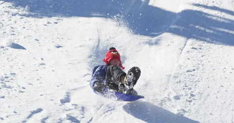Young boy hitting bumps while sliding do... | Stock Video | Pond5