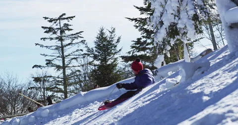 Young boy hitting bumps while sliding do... | Stock Video | Pond5