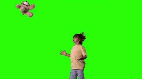 Young boy jumping up and catching teddy ... | Stock Video | Pond5
