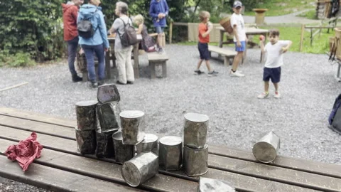 Young Boy Knocking Down Tin Cans with a ... | Stock Video | Pond5