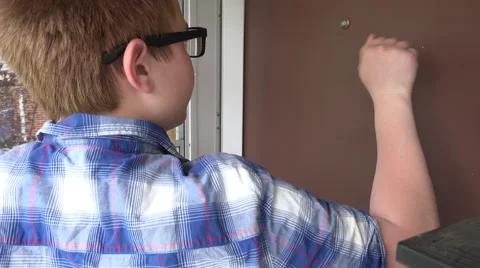 Young boy knocks on front door then look... | Stock Video | Pond5
