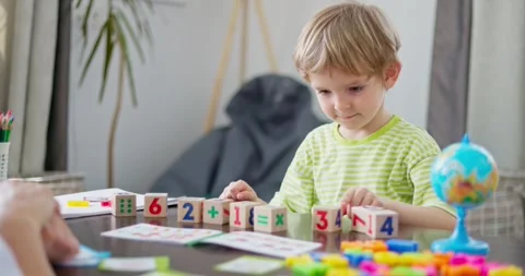 Young boy learning math with wooden bloc... | Stock Video | Pond5