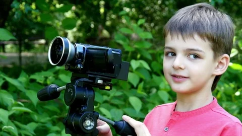 Young boy looks into video camera on bac... | Stock Video | Pond5