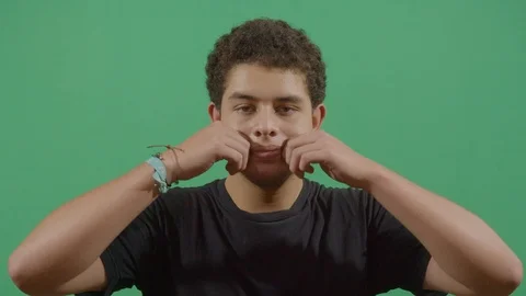 young boy pinching both cheeks in ecuado... | Stock Video | Pond5