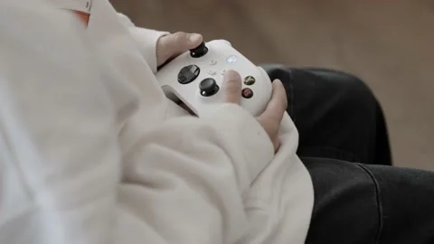 Young boy playing a game on XBOX and hol... | Stock Video | Pond5