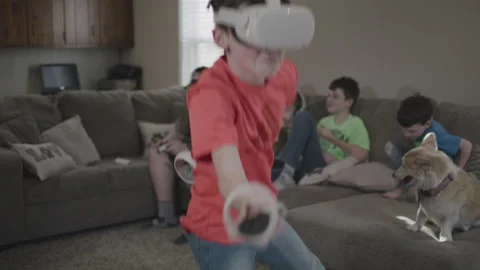 Young boy playing VR jumping around othe... | Stock Video | Pond5