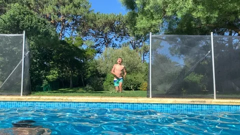 Young boy running and jumping into swimm... | Stock Video | Pond5