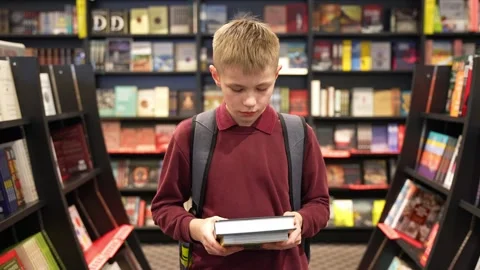 Young boy searching for new book in the ... | Stock Video | Pond5