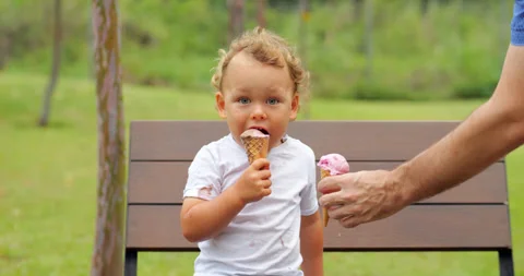 Young boy sits motionless staring at cam... | Stock Video | Pond5