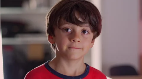 Young boy smiling gently at the camera, ... | Stock Video | Pond5