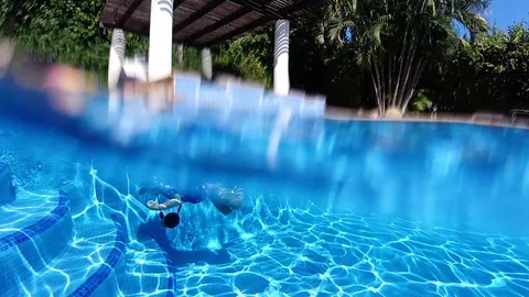 Young Boy Swimming In A Pool With A Blue... | Stock Video | Pond5