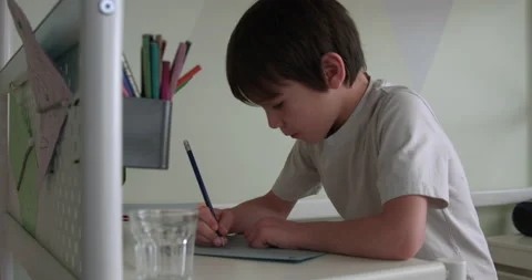Young boy writing down on paper in bedro... | Stock Video | Pond5