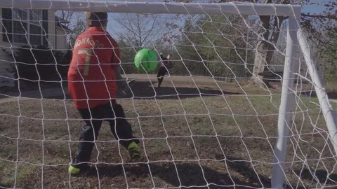 Young boys playing soccer in front yard ... | Stock Video | Pond5