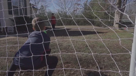 Young boys playing soccer in front yard ... | Stock Video | Pond5