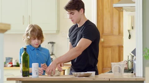 Young brother helping older brother to m... | Stock Video | Pond5