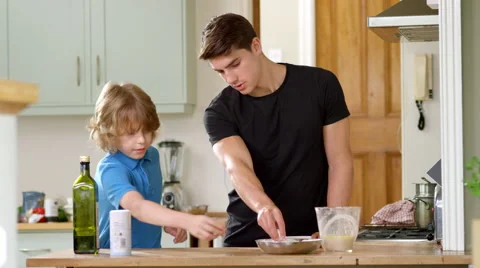 Young brother helping older brother to m... | Stock Video | Pond5