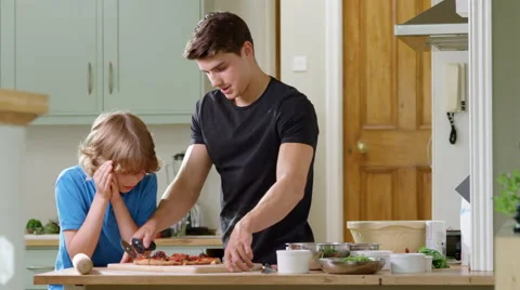 Young brother helping older brother to m... | Stock Video | Pond5