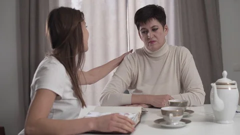 Young brunette girl calming down older w... | Stock Video | Pond5