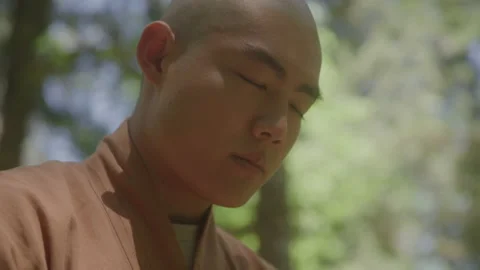 Young Buddhist Monk Sitting with Eyes Cl... | Stock Video | Pond5