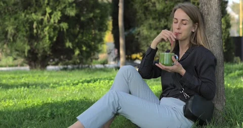 Young business woman drinking green smoo... | Stock Video | Pond5