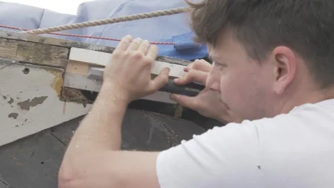 A Young carpenter chiseling inner gunwal... | Stock Video | Pond5