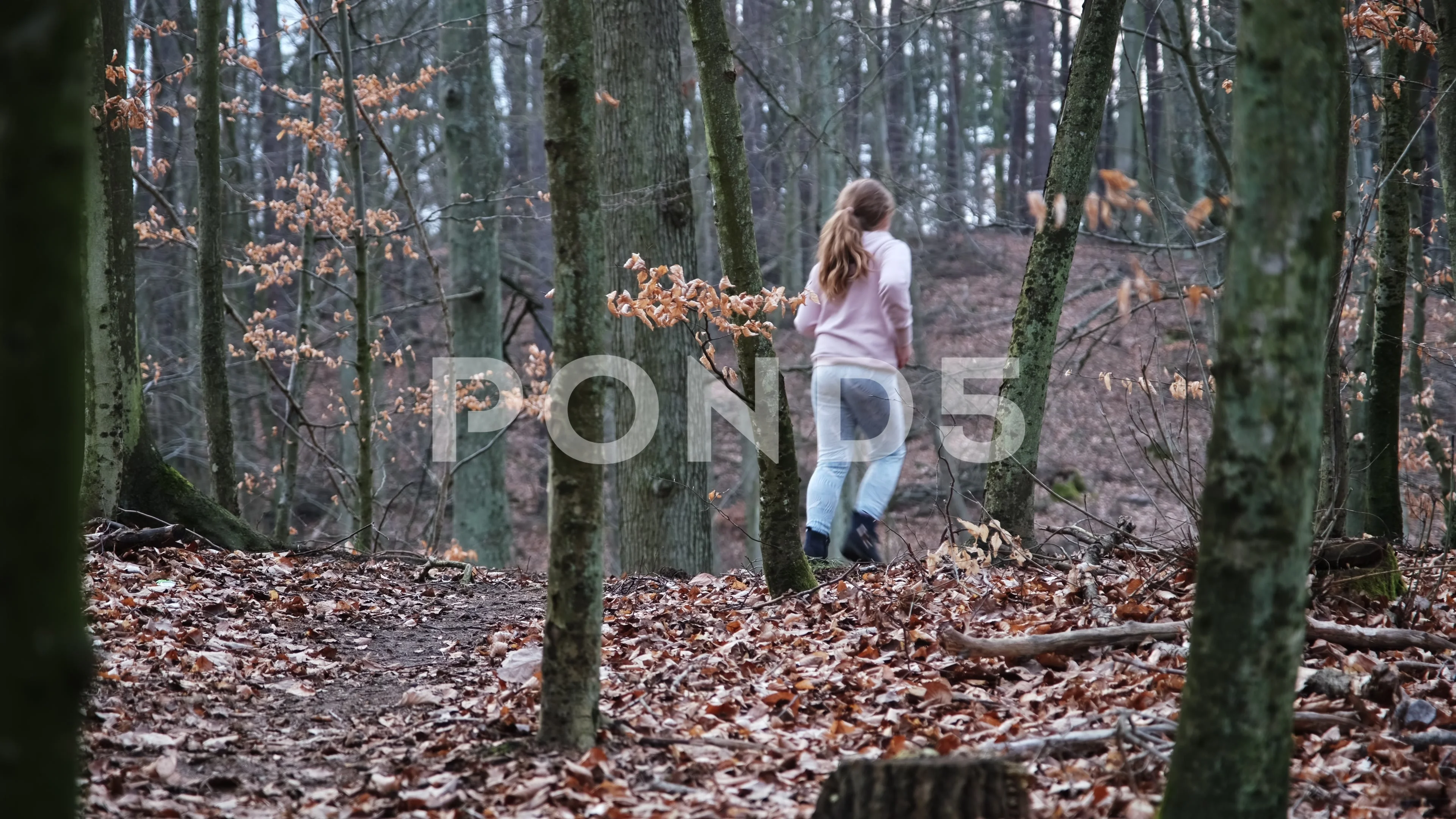 Scared Girl Running Away In The Woods