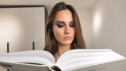 Young charming female student reading bo... | Stock Video | Pond5