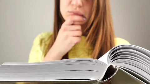 Young charming female student reading bo... | Stock Video | Pond5