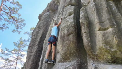 Young child boy climbing steep wall of r... | Stock Video | Pond5