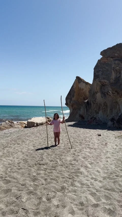 A young child holding sticks, playing on... | Stock Video | Pond5