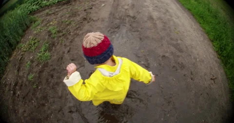 Young Child Jumping In Mud Puddle | Stock Video | Pond5