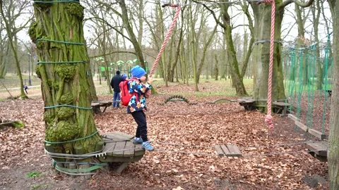 Young child playing on an obstacle route... | Stock Video | Pond5