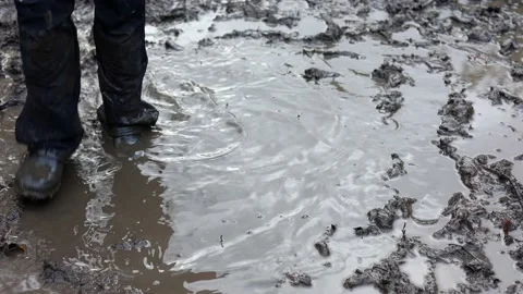 Young child splashing in a muddy puddle,... | Stock Video | Pond5
