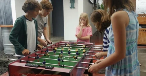 Young children playing foosball together... | Stock Video | Pond5