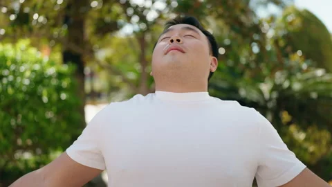 Young chinese man breathing standing at ... | Stock Video | Pond5