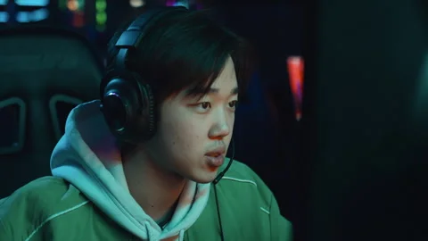 Young Chinese Man in Headset Playing Vid... | Stock Video | Pond5