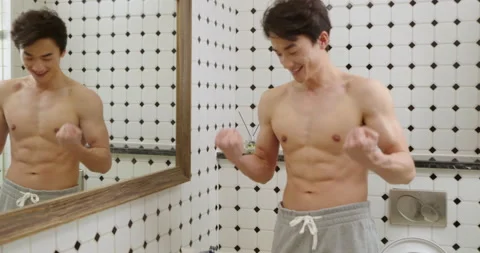 Young Chinese man showing muscles in fro... | Stock Video | Pond5