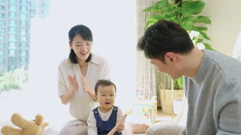 Young Chinese parents playing with their... | Stock Video | Pond5