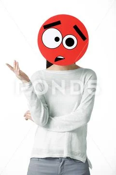 Young Chinese woman with a confused emoticon face in front of her face ...