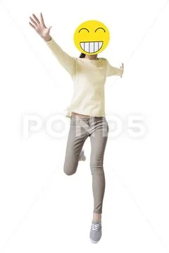 Young Chinese woman running with a happy emoticon face in front of her ...