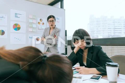 Young company business woman looking at employees ~ Premium Photo #81782454